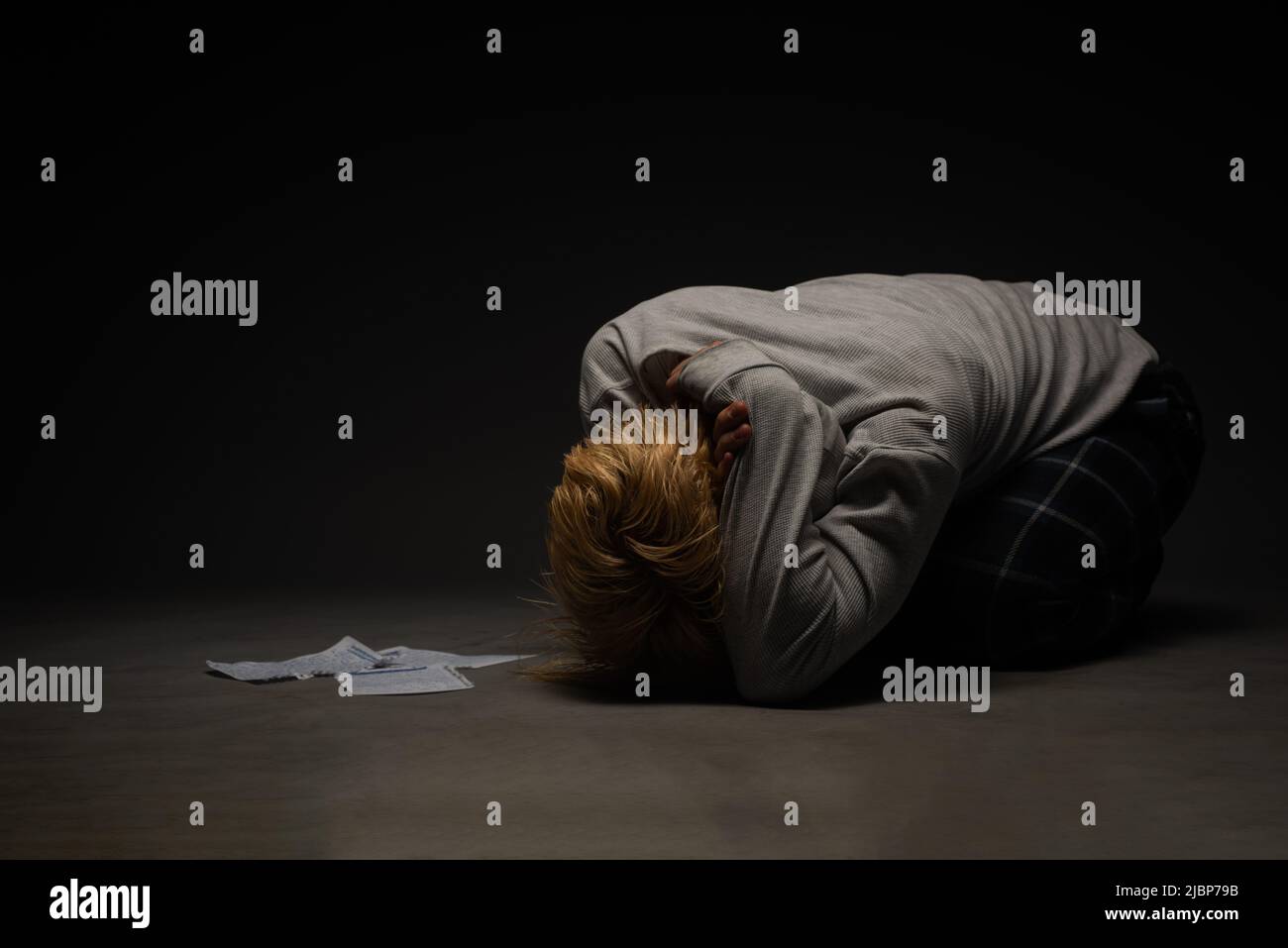 Depressed and sad boy is crying about the one letter out of three Stock ...