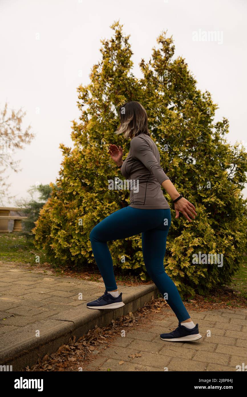 Middle aged woman running on the stairs in the park Stock Photo - Alamy
