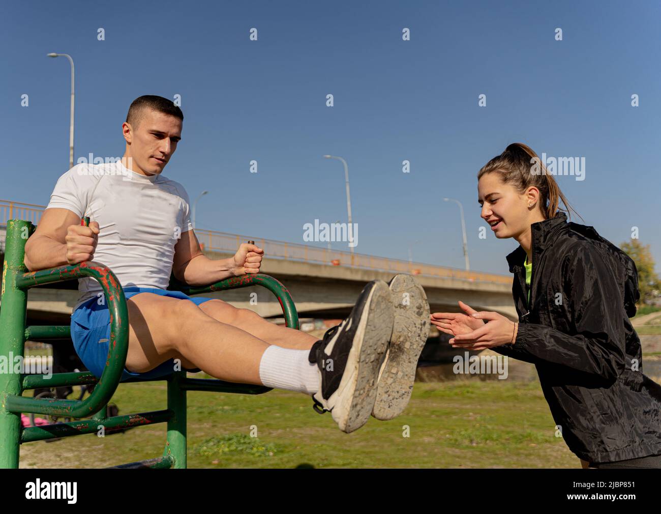 Two attractive and amazing fit friends are helping each other with the ...