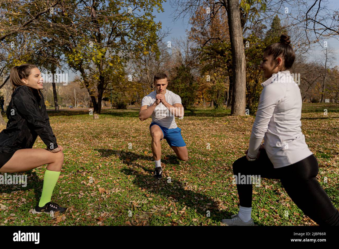 Three attractive and amazing fit friends are stretching Stock Photo - Alamy
