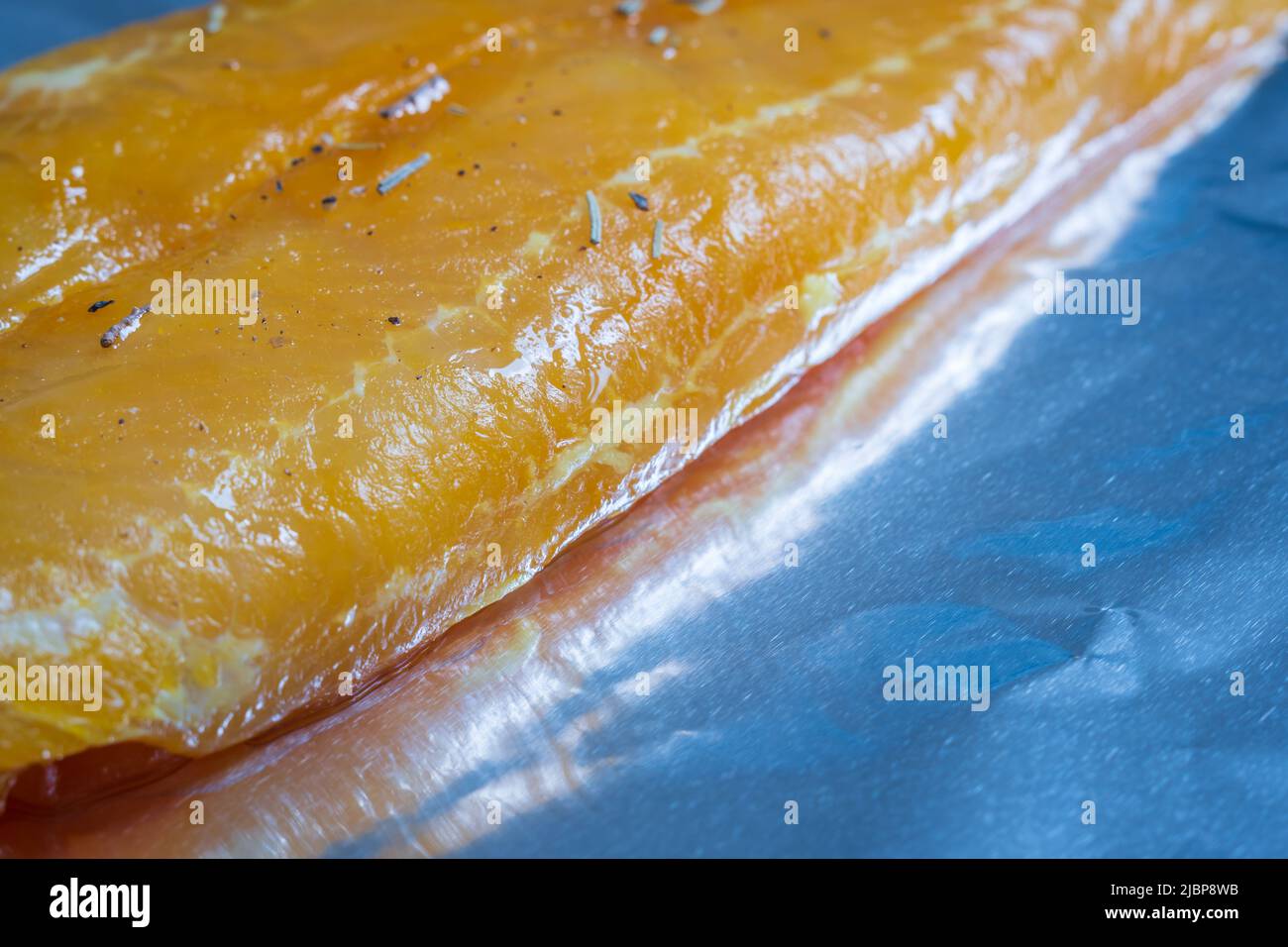 Raw seasoned fish fillets on baking tray closeup Stock Photo - Alamy