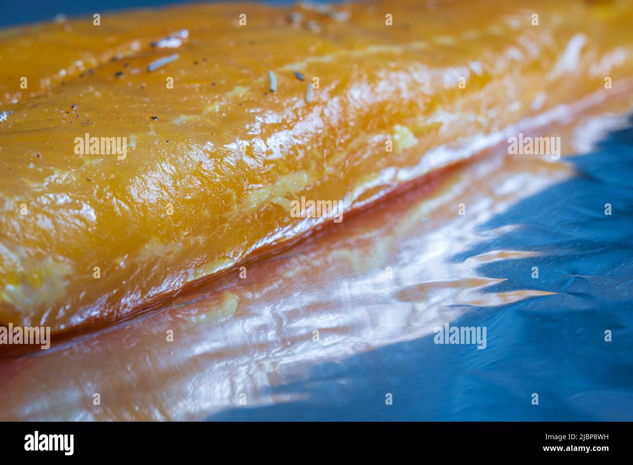 Raw seasoned fish fillets on baking tray closeup Stock Photo - Alamy