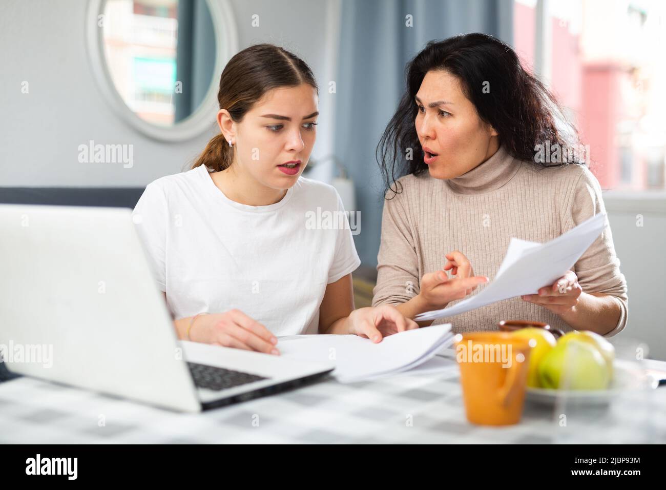 Women trying to solve document problem at home Stock Photo - Alamy