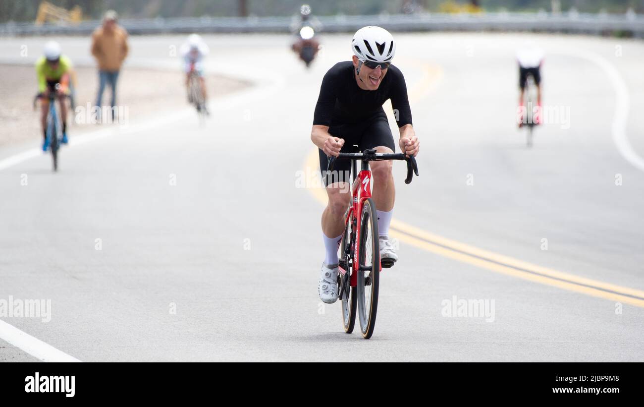 Amateur and pro cyclists compete during the time trial stage of the ...