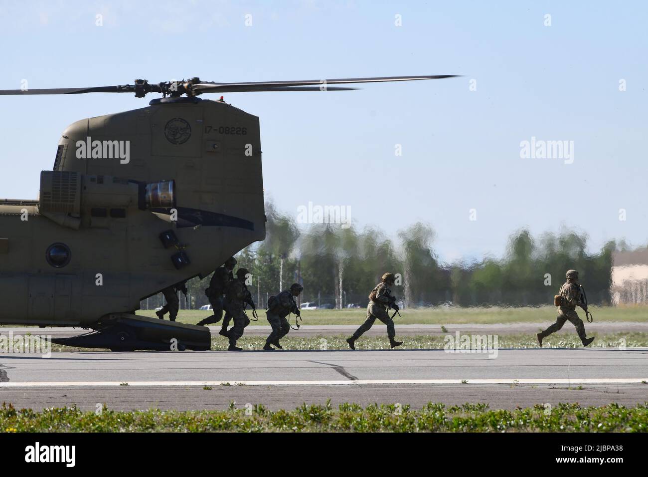 Soldiers exit a CH-47 Chinook helicopter during an air assault mission ...