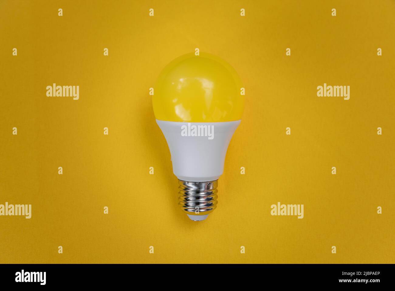 A light bulb over a yellow background Stock Photo - Alamy