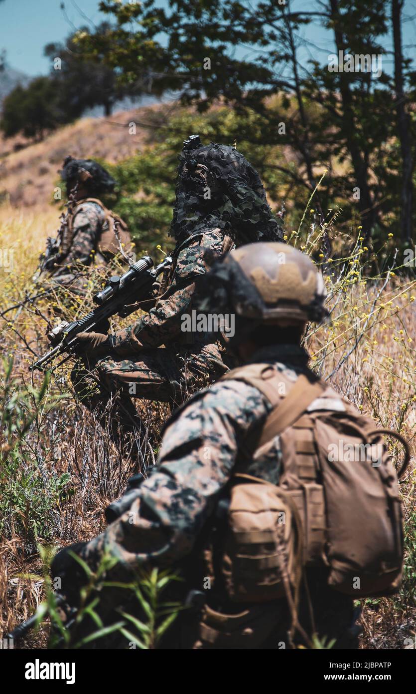 U.S. Marines with 1st Marine Regiment, 1st Marine Division, wait to ...