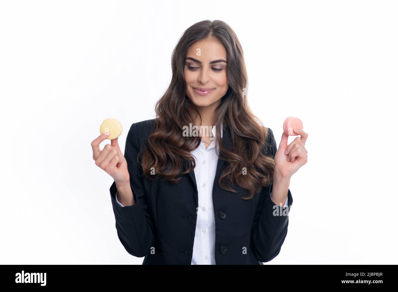 Young woman eating delicious macaroon on white background. Girl eat the ...