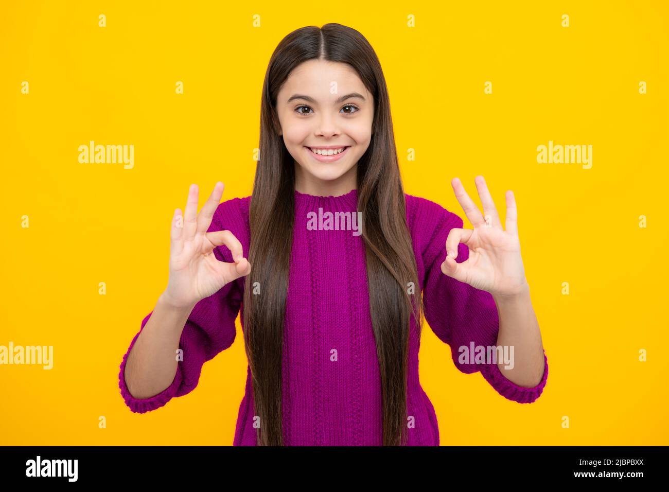 Beautiful child girl making ok sign on yellow background. Portrait of ...