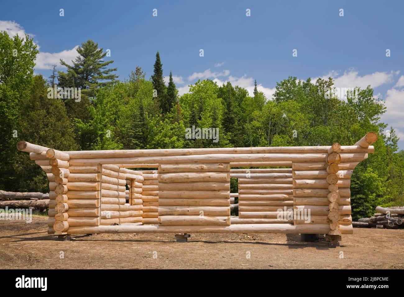 Unfinished Scandinavian log cabin being built with Eastern white pine ...