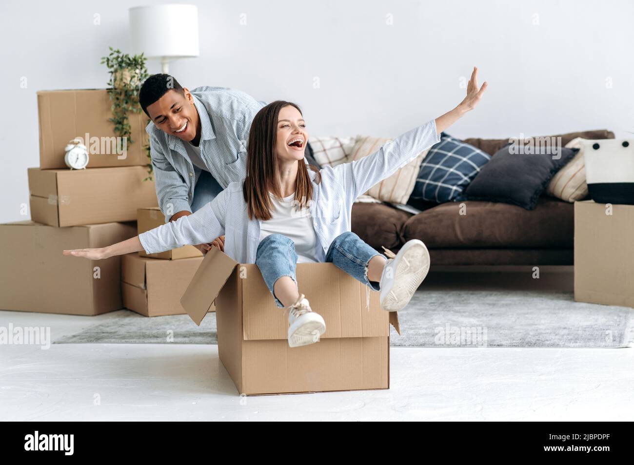 New home, relocation. Happy mixed race young family couple, bought ...