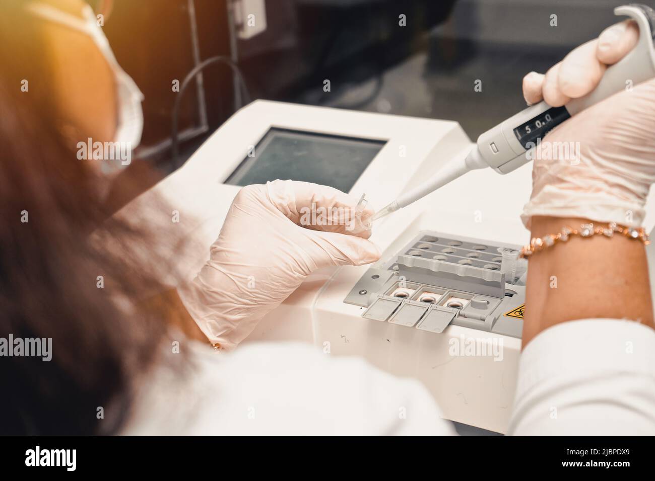 Clinical analyst testing medical blood sample in a hospital laboratory ...
