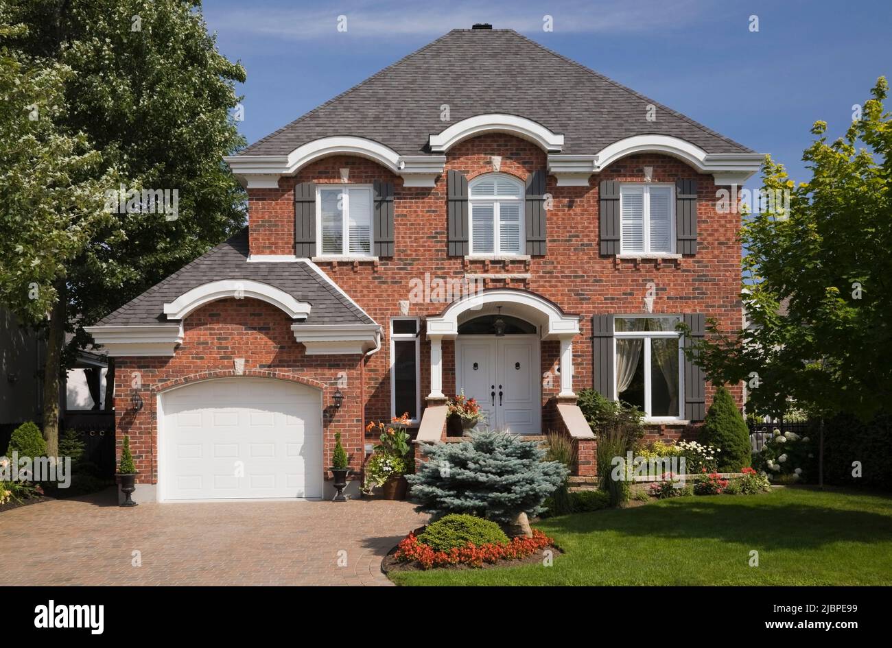 Red brick cottage style home with charcoal colored asphalt shingles ...