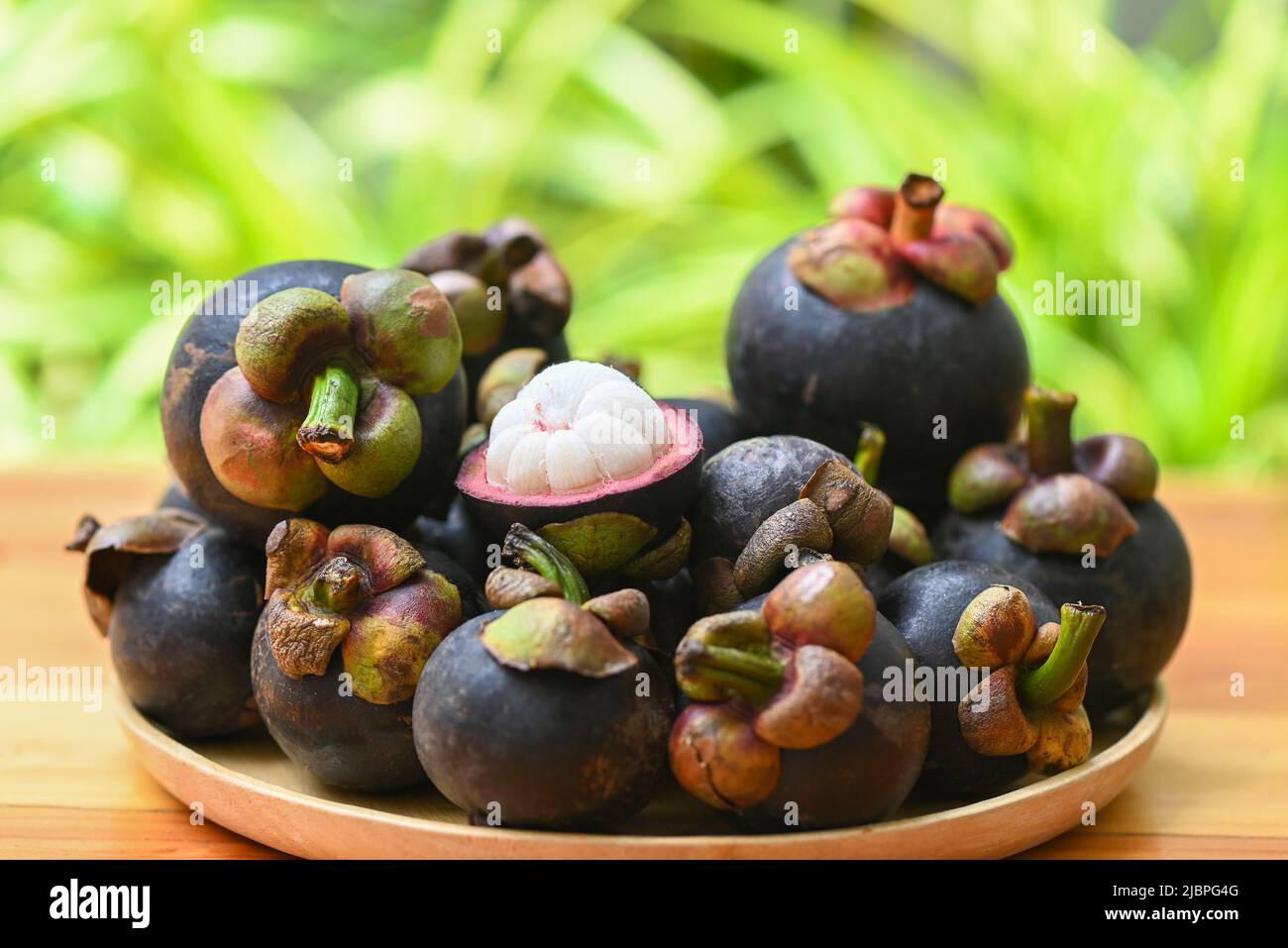 Mangosteen on plate and nature background, fresh ripe mangosteen peeled ...