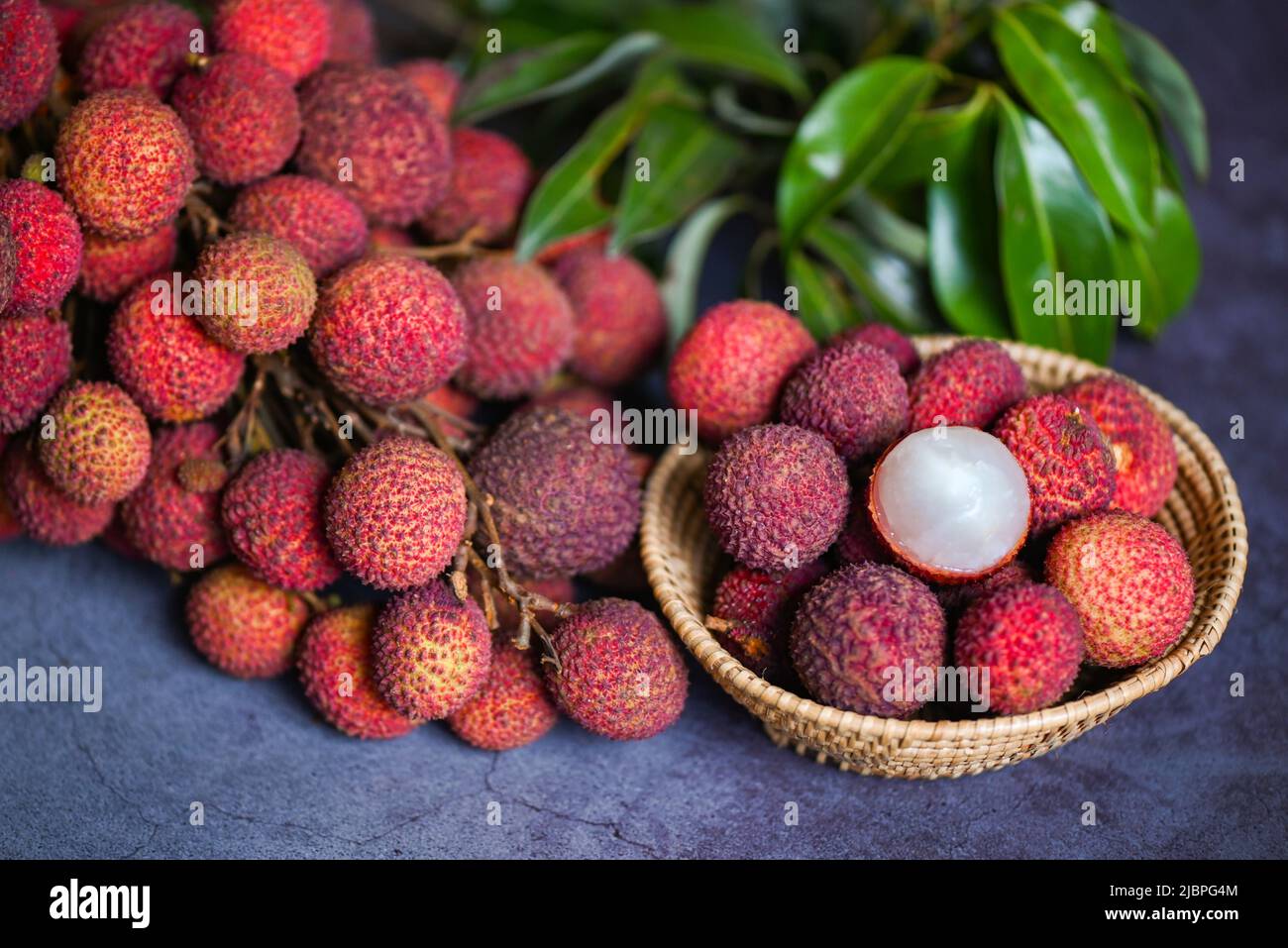 Lychee fruit with green leaf on black background, fresh ripe lychee ...