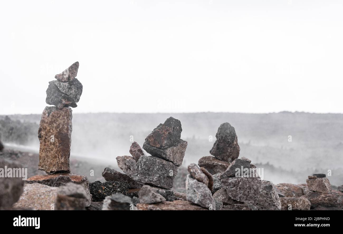 Close up of spiritual apachetas (stone stack) in beautiful misty ...