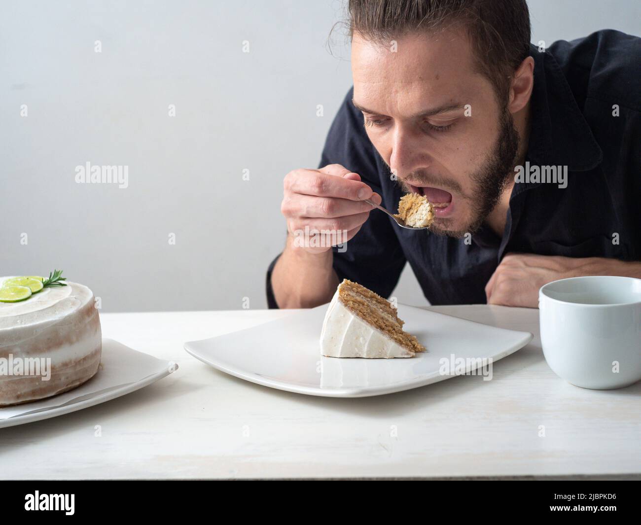 A Man Eats a Piece of Vegan Lemon Layer Cake with Almond, Coconut and ...