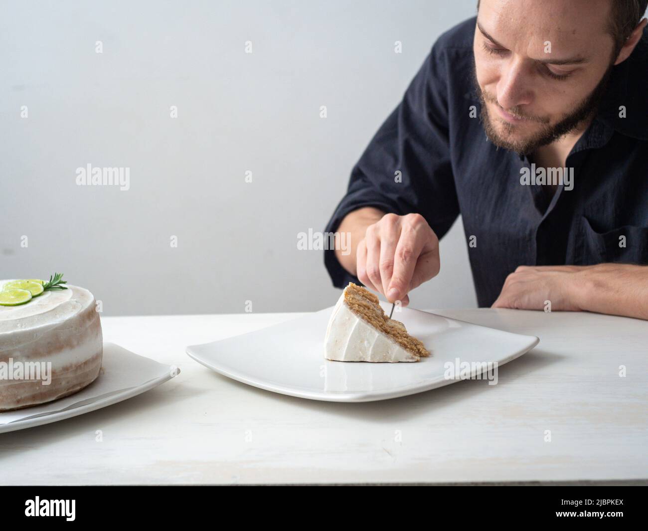 A Man Eats a Piece of Vegan Lemon Layer Cake with Almond, Coconut and ...