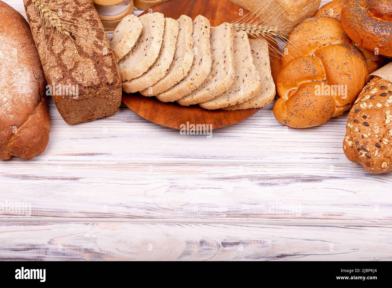 Whole grain bread put on kitchen cutting board on wooden background ...
