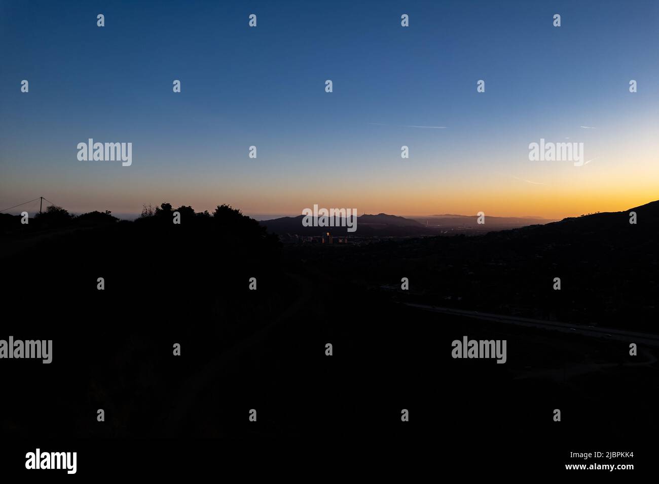 Sunset, hills and freeway Stock Photo - Alamy