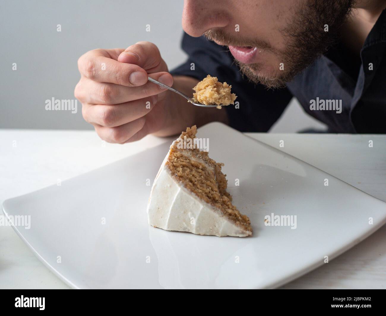 A Man Eats a Piece of Vegan Lemon Layer Cake with Almond, Coconut and ...