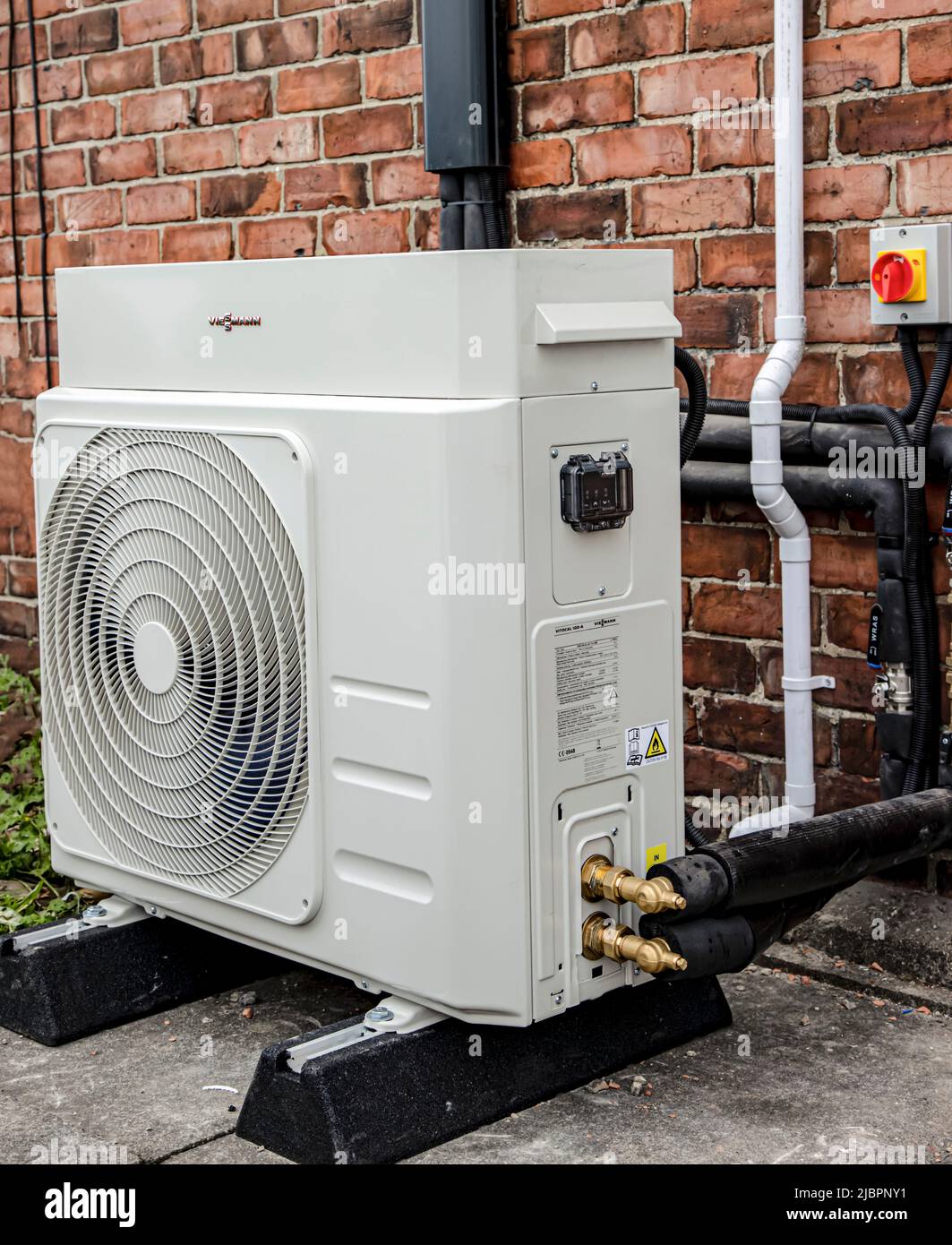 Air source heat pump installed outside a building. Heat pumps take heat ...