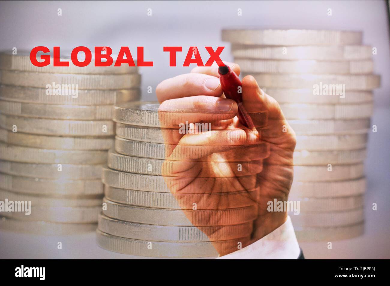 Hand writing the word “Global Tax” with the money as background ...