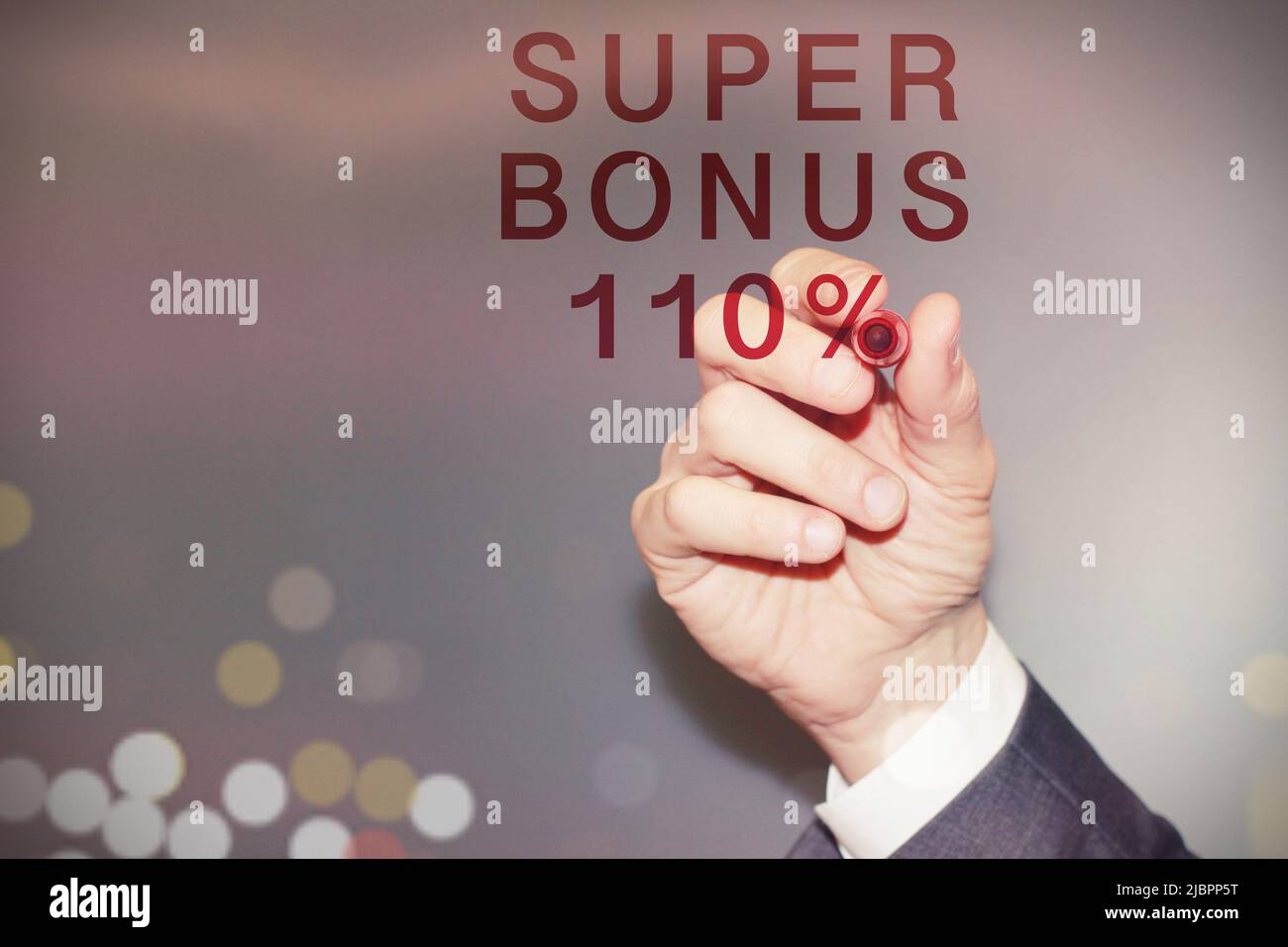 Business man writing with a red pen “super bonus 110%” Stock Photo - Alamy