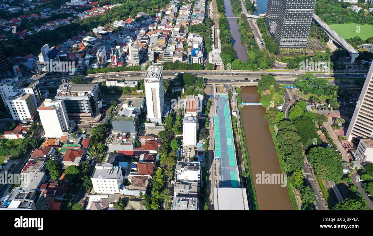Aerial view of the river flows through the Jakarta city at day time ...