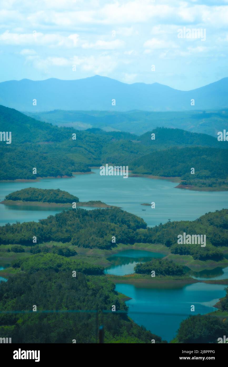 Morning at the Ta Dung lake or Dong Nai 3 lake with green hills and ...