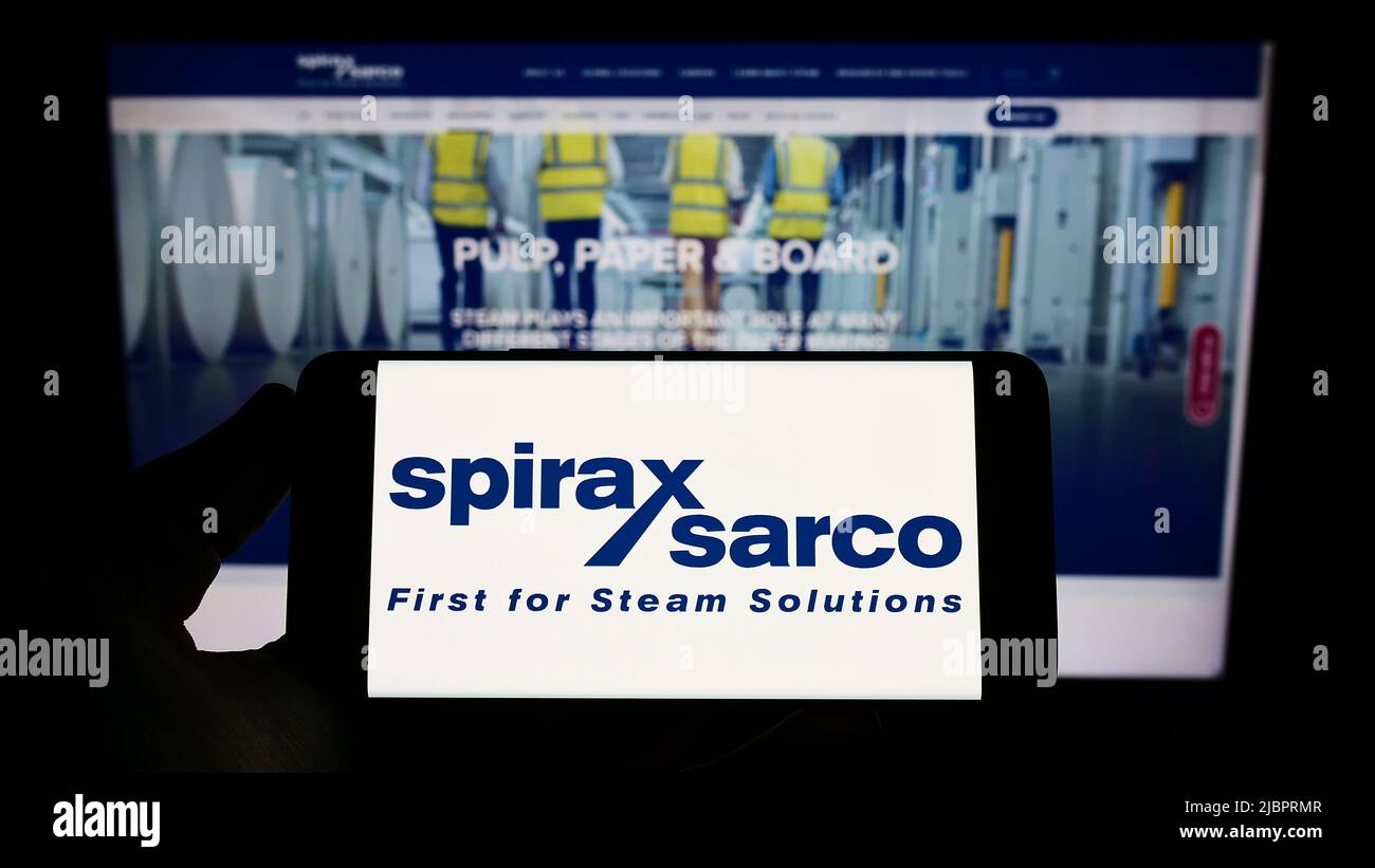 Person holding smartphone with logo of British company Spirax-Sarco ...