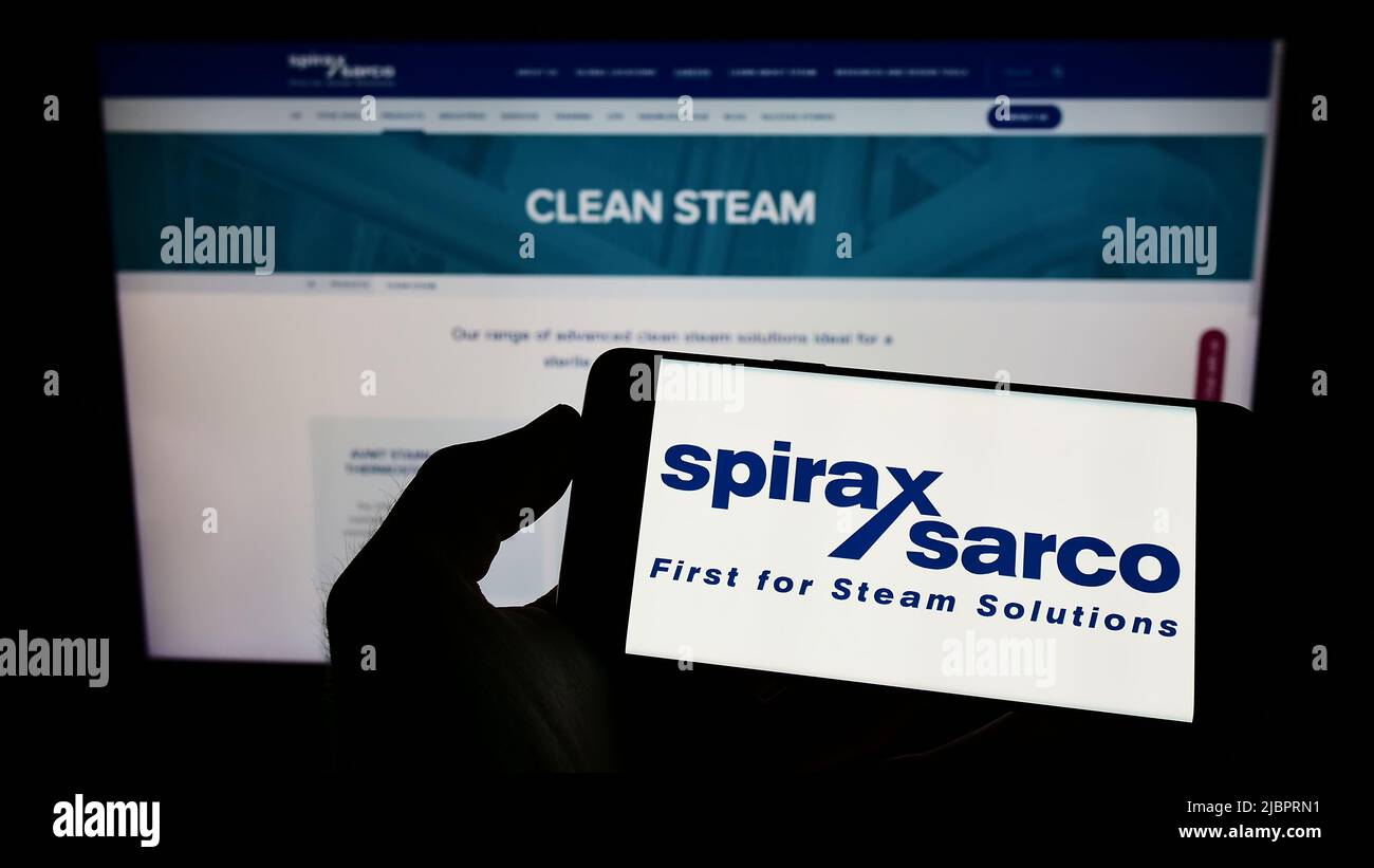 Person holding cellphone with logo of British company Spirax-Sarco ...