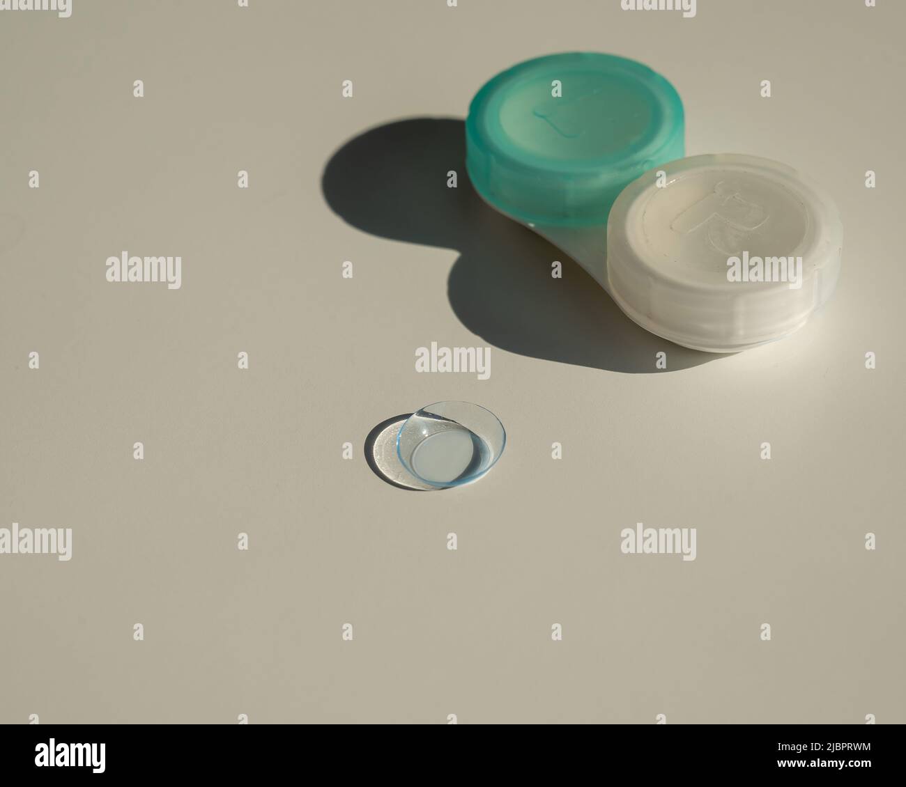 Contact lenses and a storage container on a white table Stock Photo - Alamy