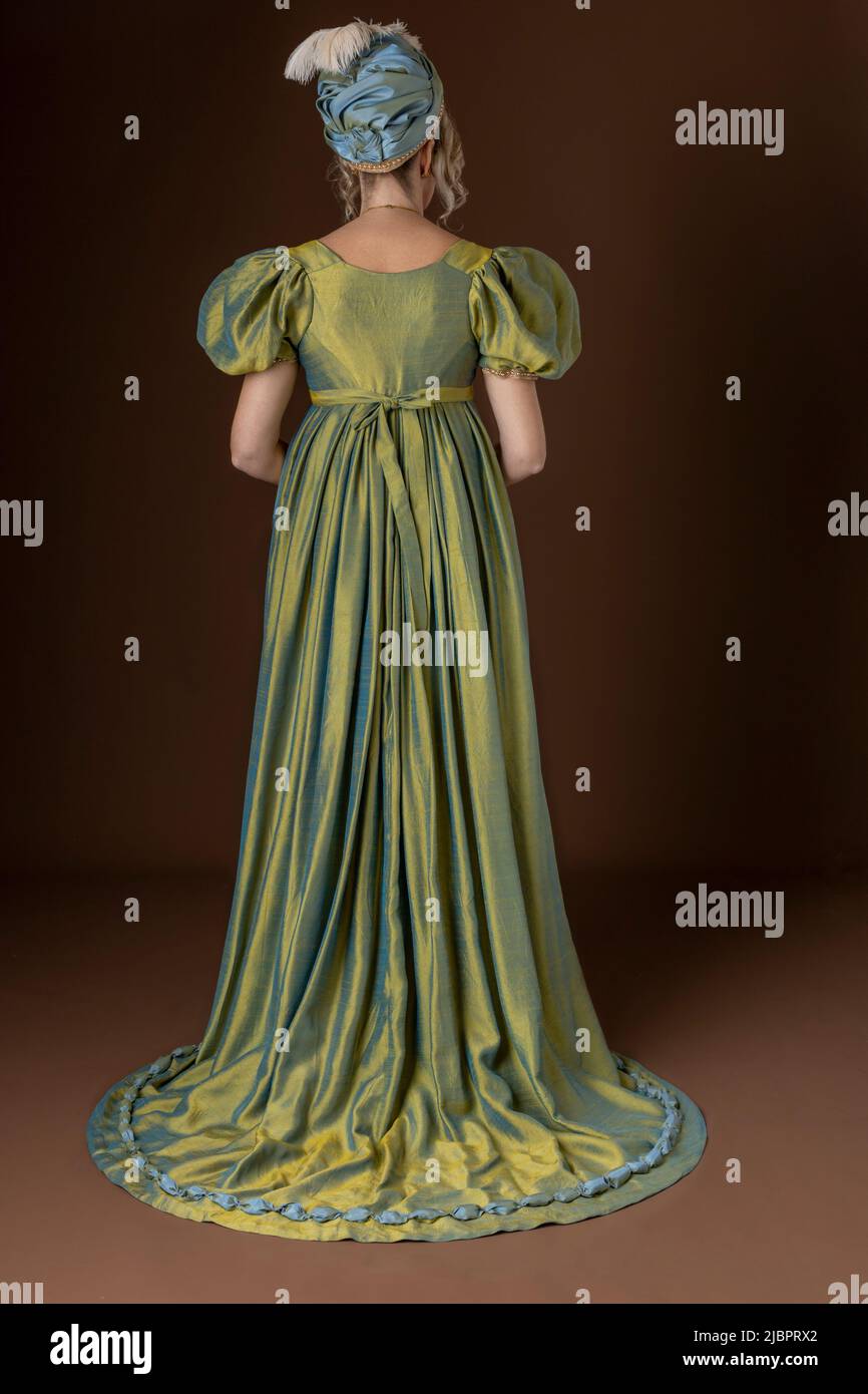 A Regency woman wearing a green shot silk dress and turban Stock Photo ...