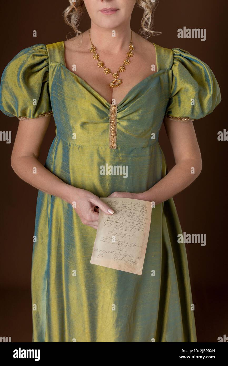 A Regency woman wearing a green shot silk dress and turban Stock Photo ...