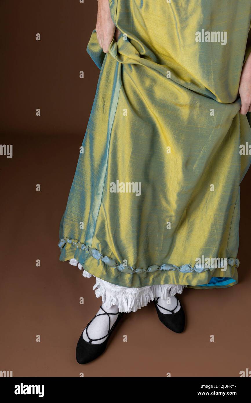 A Regency woman wearing a green shot silk dress and turban Stock Photo ...