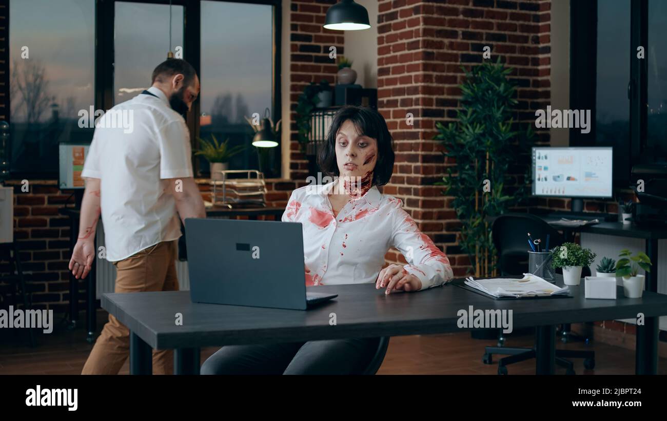 Spooky zombie sitting desk waving hi-res stock photography and images ...