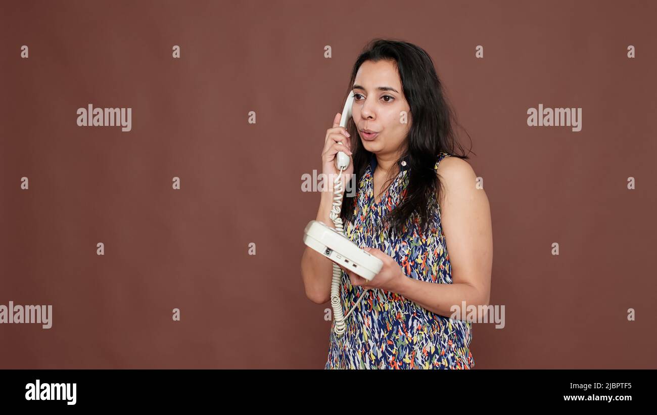 Indian woman using landline phone call to have remote conversation with ...