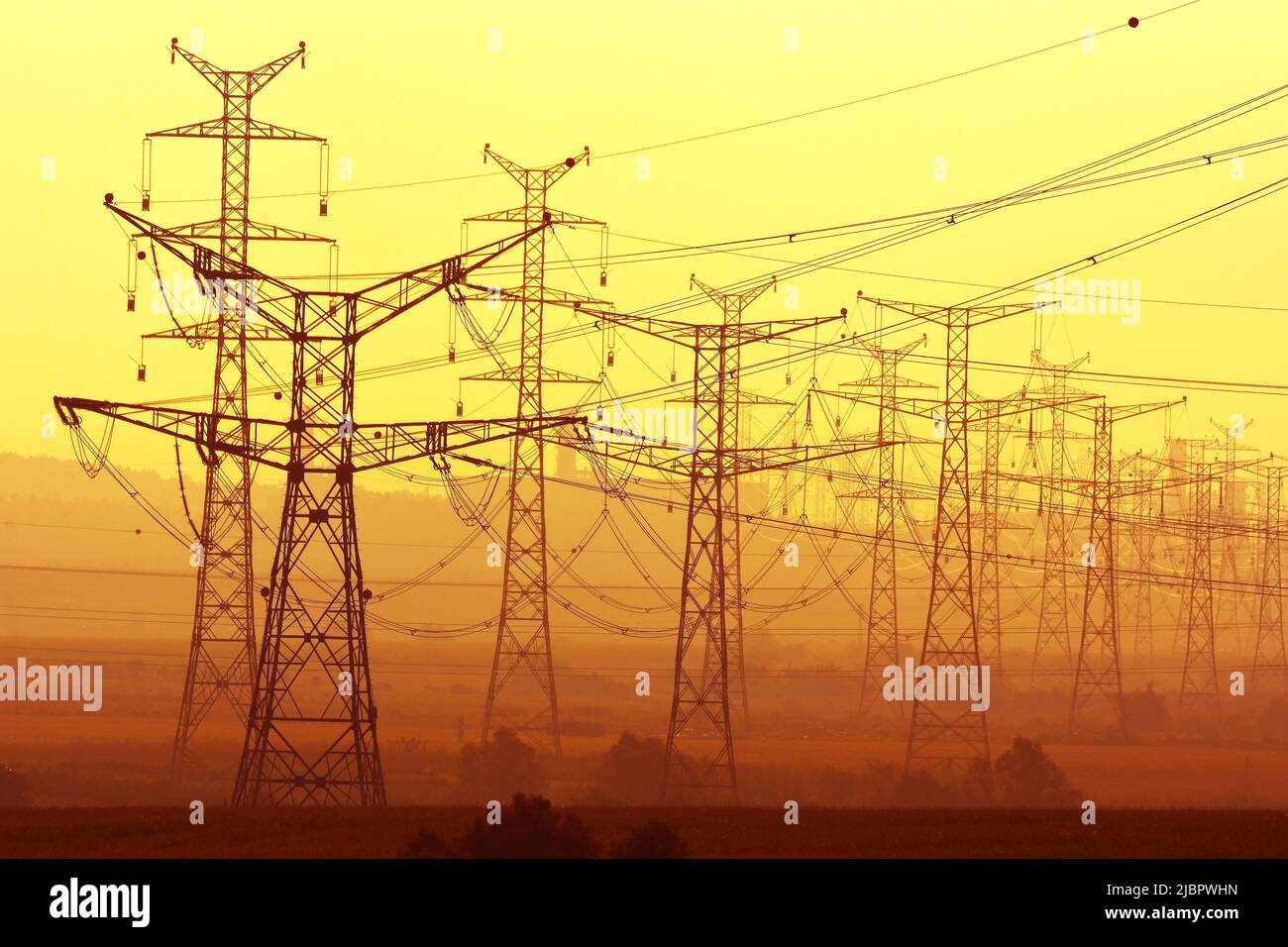 Electricity pylons at sunset Stock Photo - Alamy