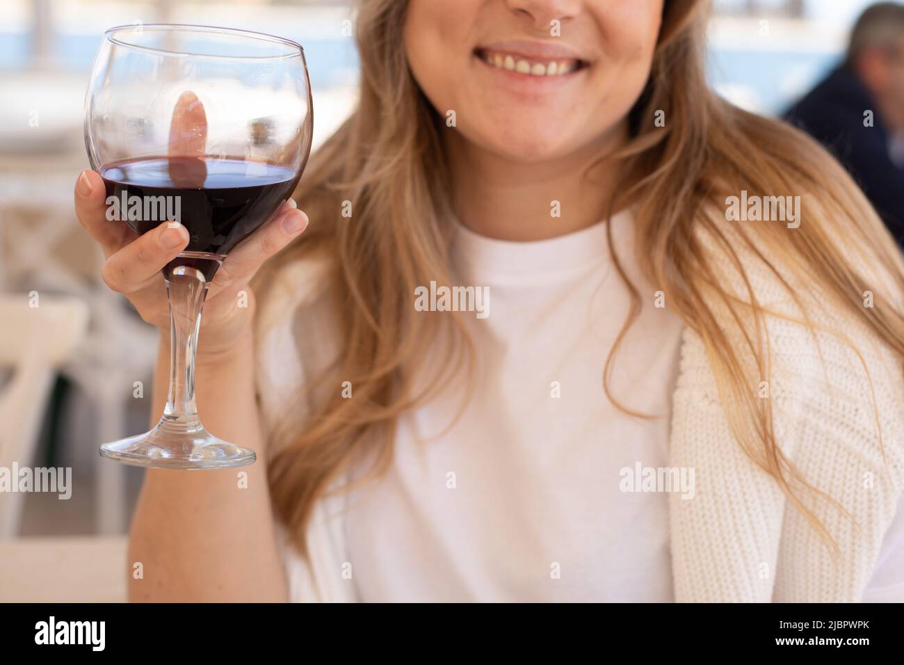 Woman raising wine glass hi-res stock photography and images - Alamy