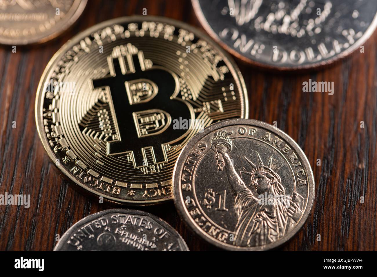 Bitcoin and one Dollar coins on Dark Wood Background. Gold BTC coin ...