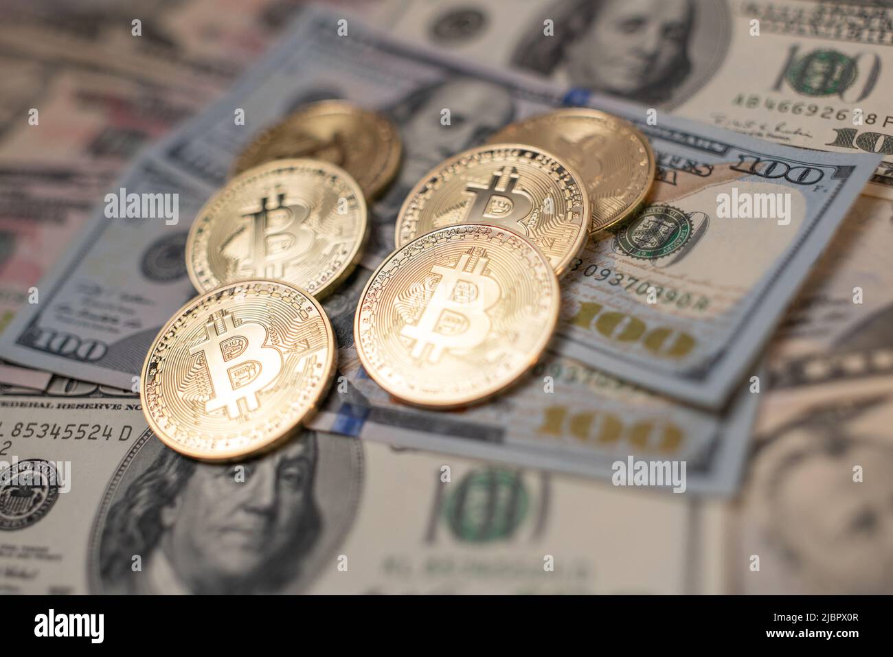 Bitcoin coin on one hundred dollar banknotes from united states of ...