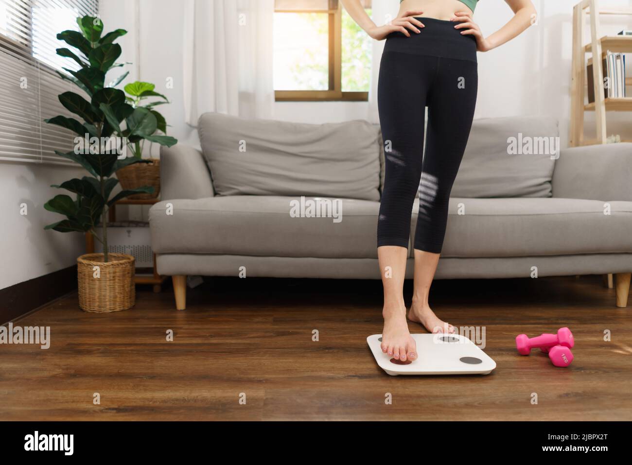 Healthy and weight loss concept, Young Asian woman stepping on weighing ...