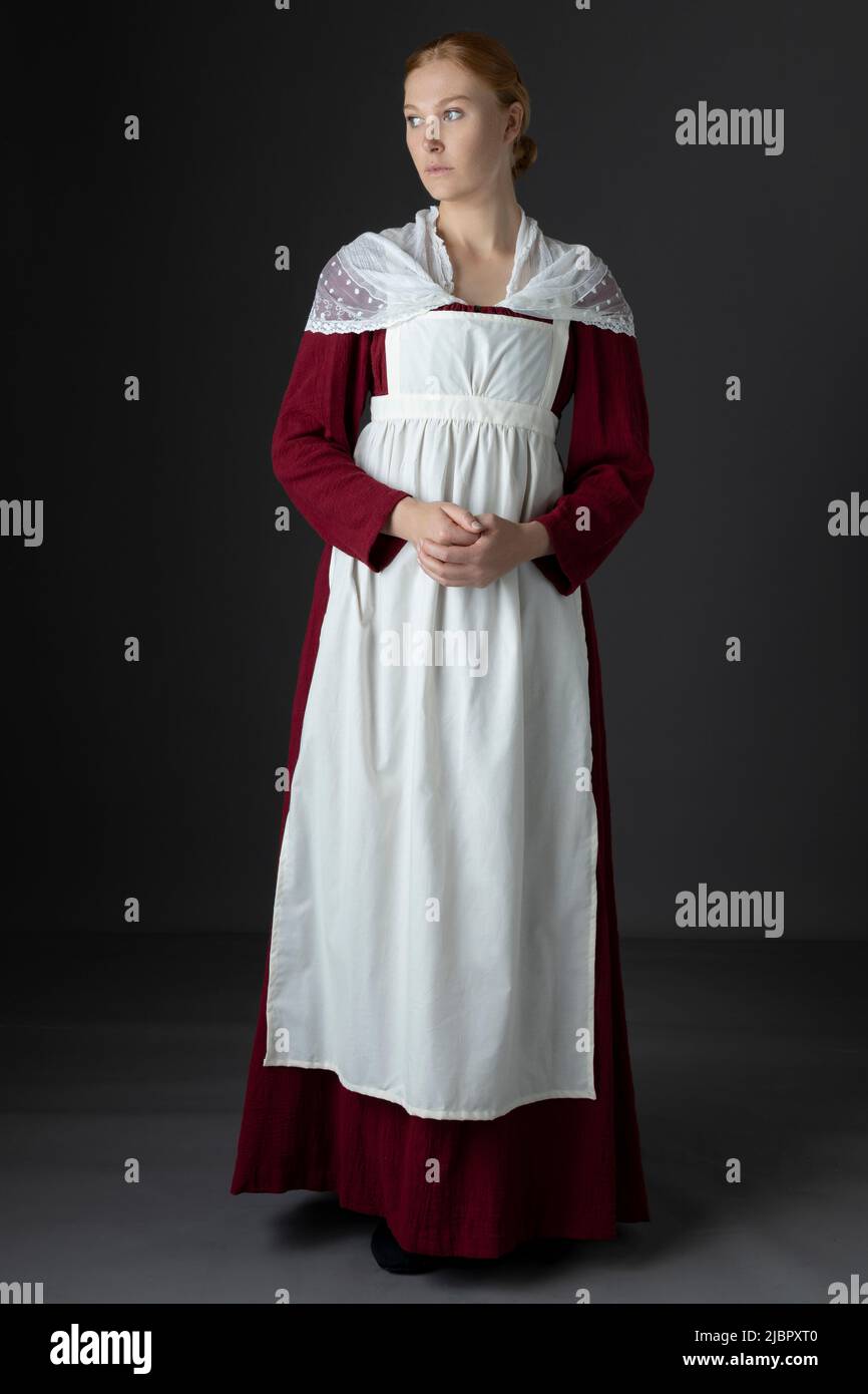A Regency serving maid wearing a red dress and an apron Stock Photo - Alamy