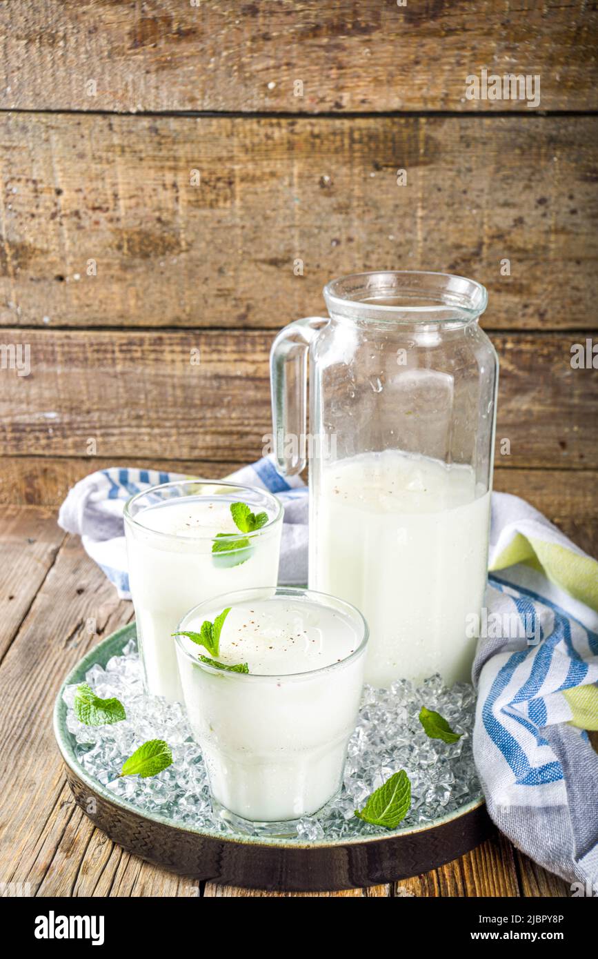 Cold Indian drink Lassi, iced coconut Lassi drink with mint leaf ...