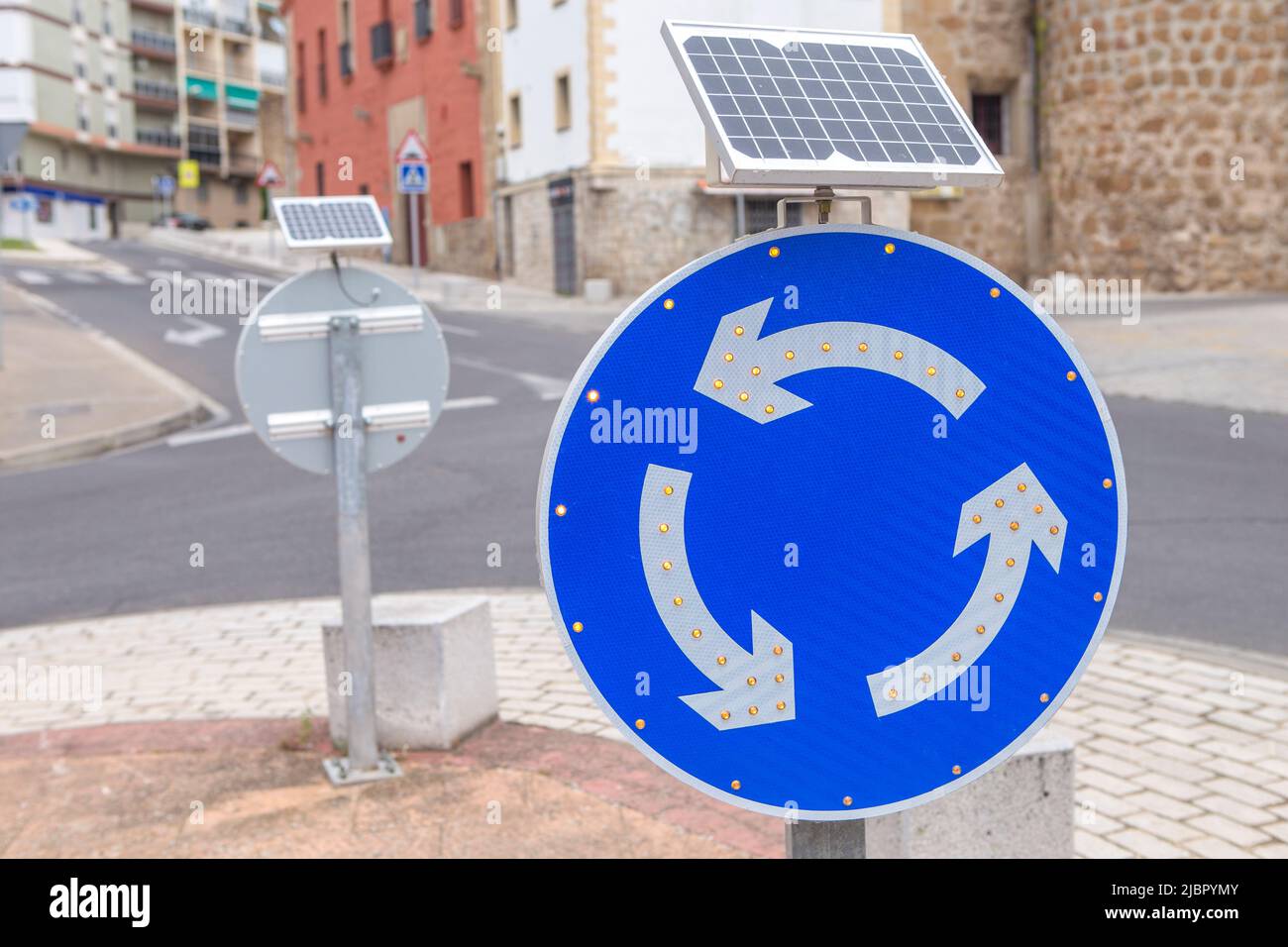 Roundabout sign powered by solar panel. Environmentally friendly ...