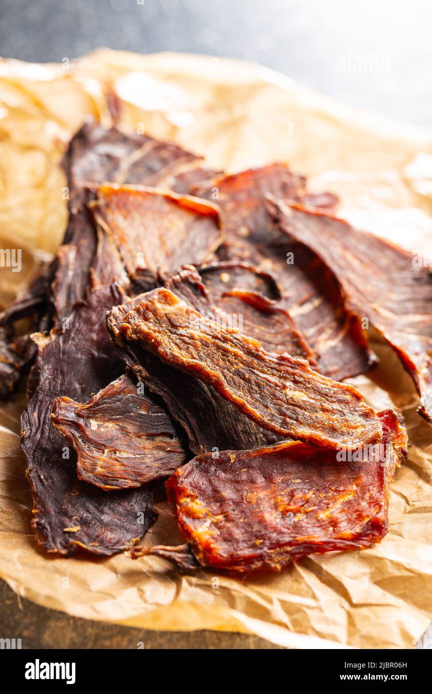 Beef jerky meat. Dried sliced meat on a paper Stock Photo - Alamy