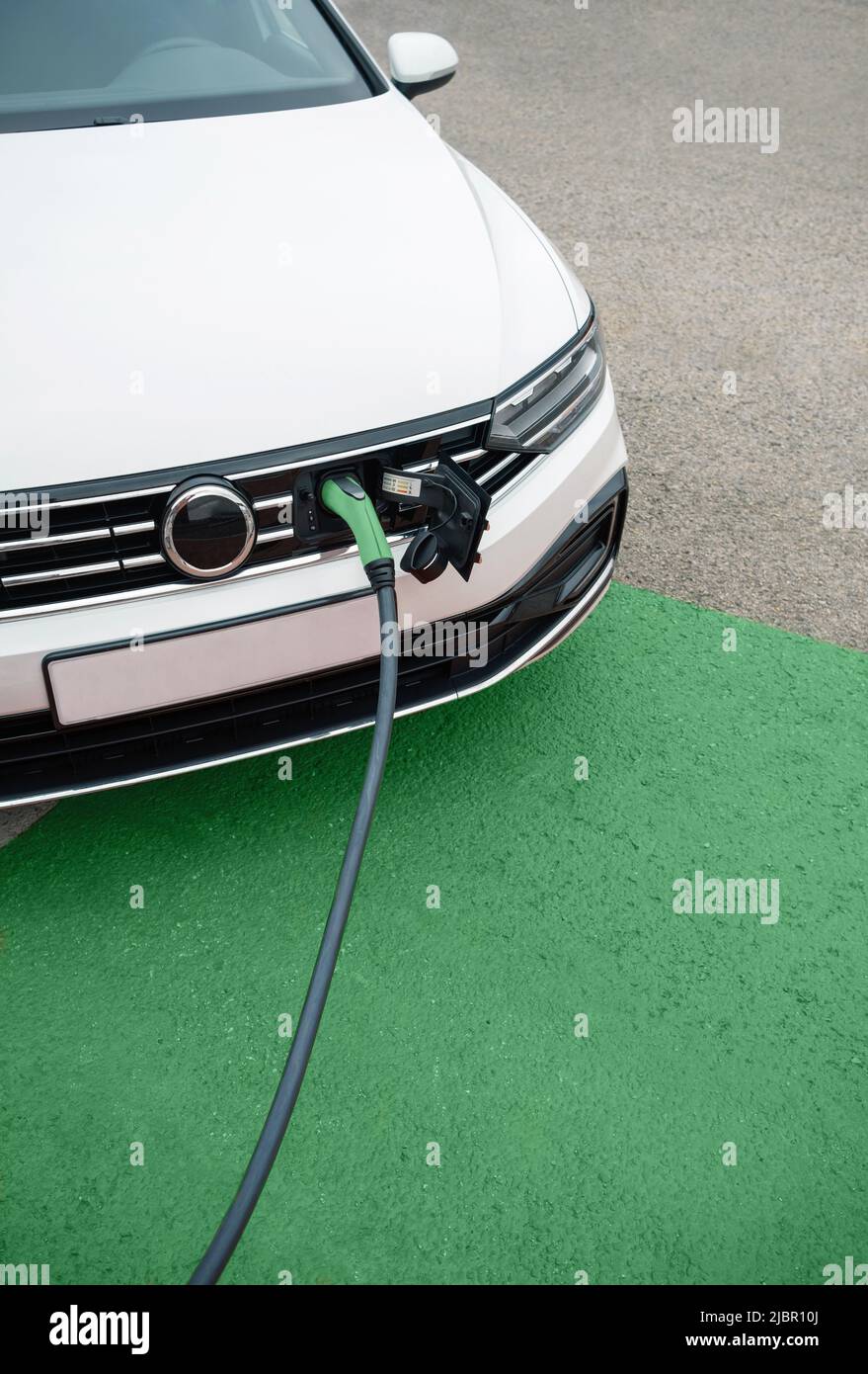 Socket plugged into electric car Stock Photo - Alamy