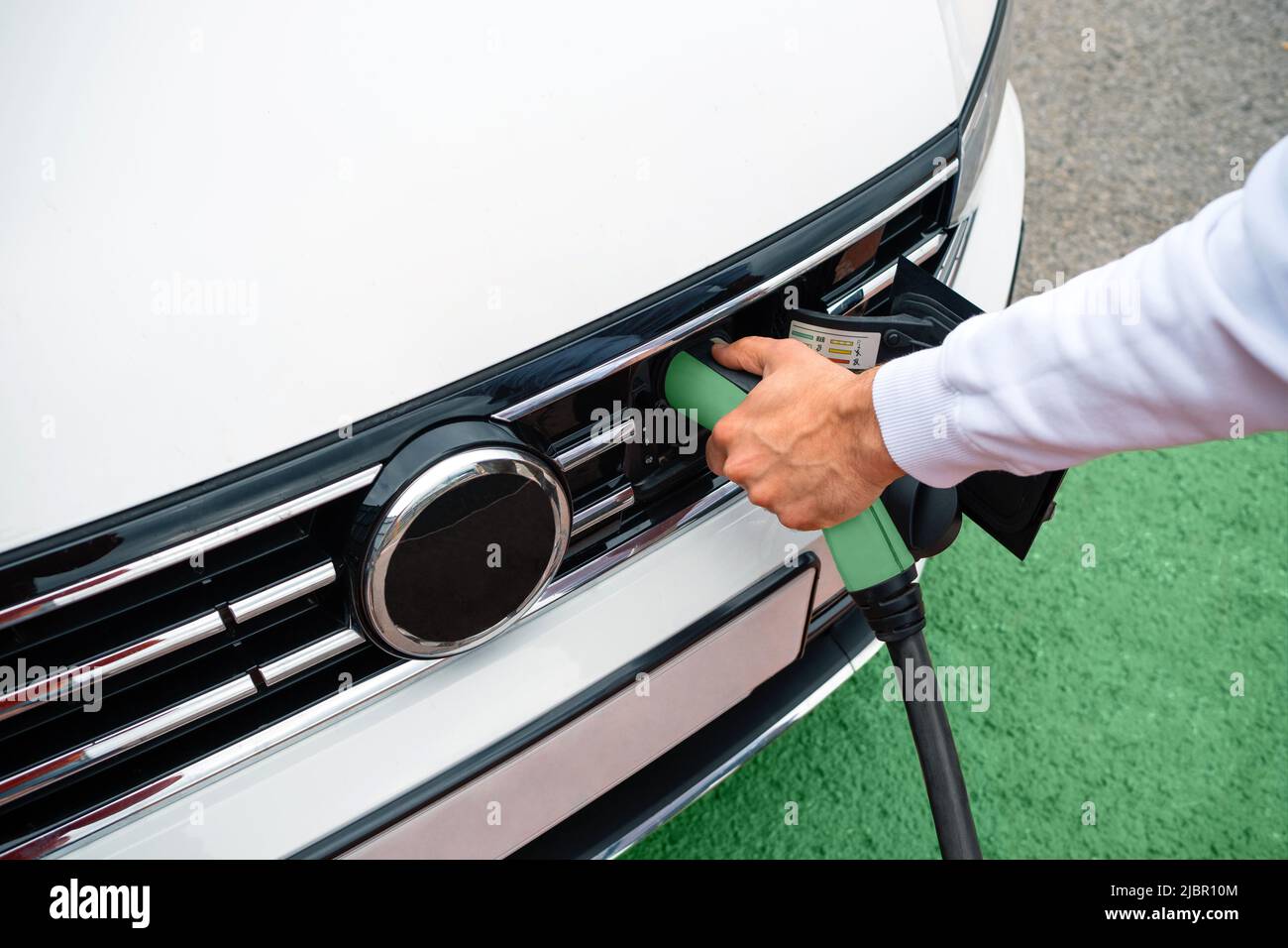 Hand holding charge plug hi-res stock photography and images - Alamy