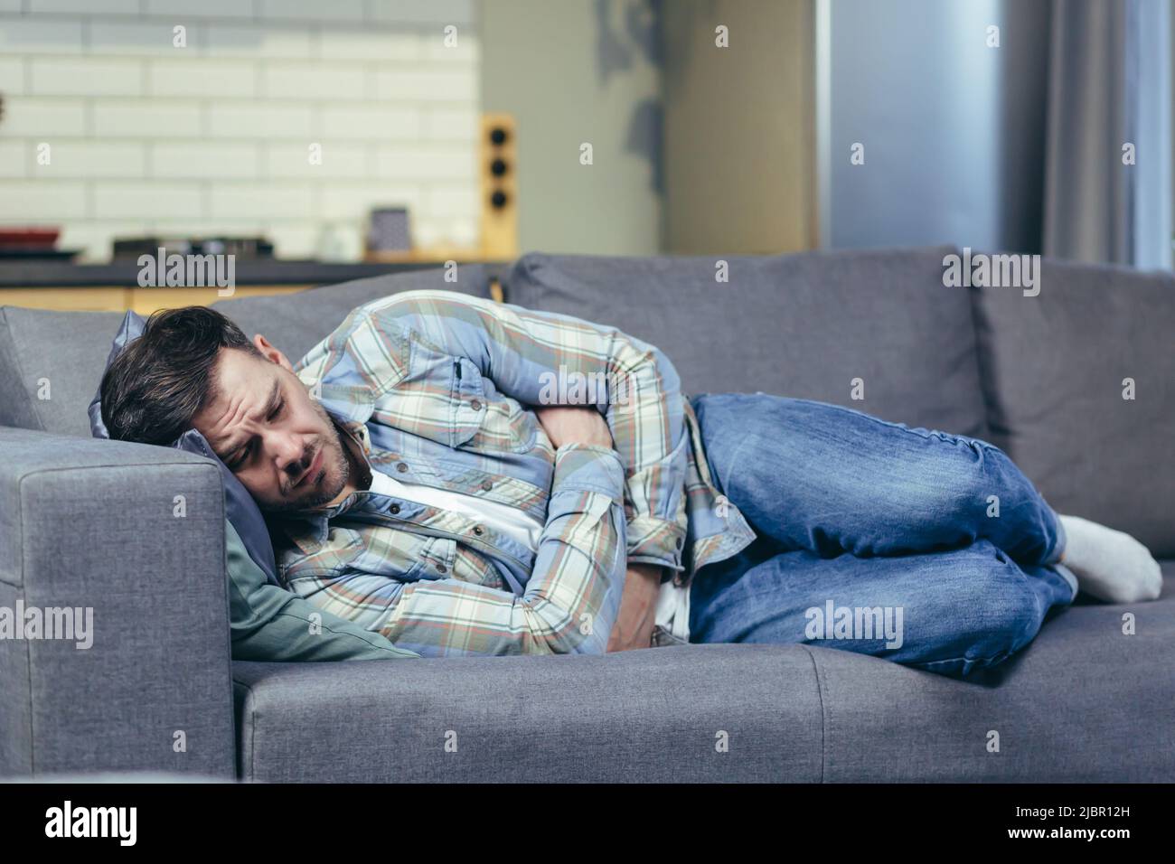 Man sleeping on sofa hi-res stock photography and images - Alamy